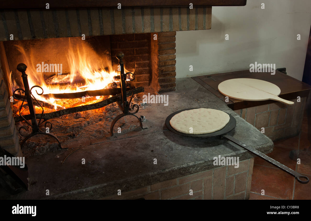 Cooking flat bread traditionally in a home in Umbria, Italy Stock Photo ...