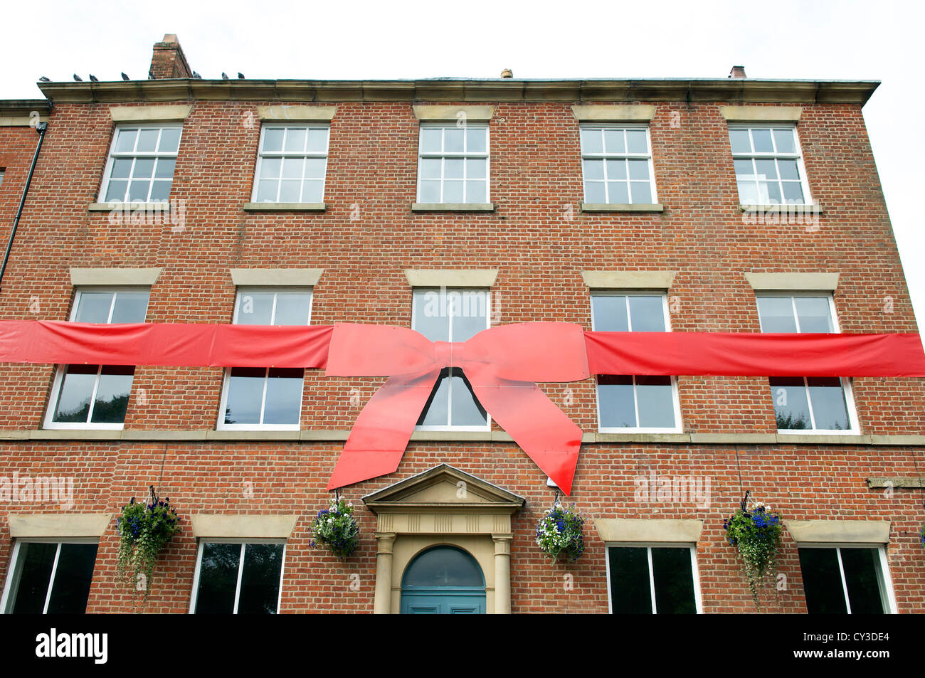 Office building wrapped with large red ribbon Stock Photo - Alamy