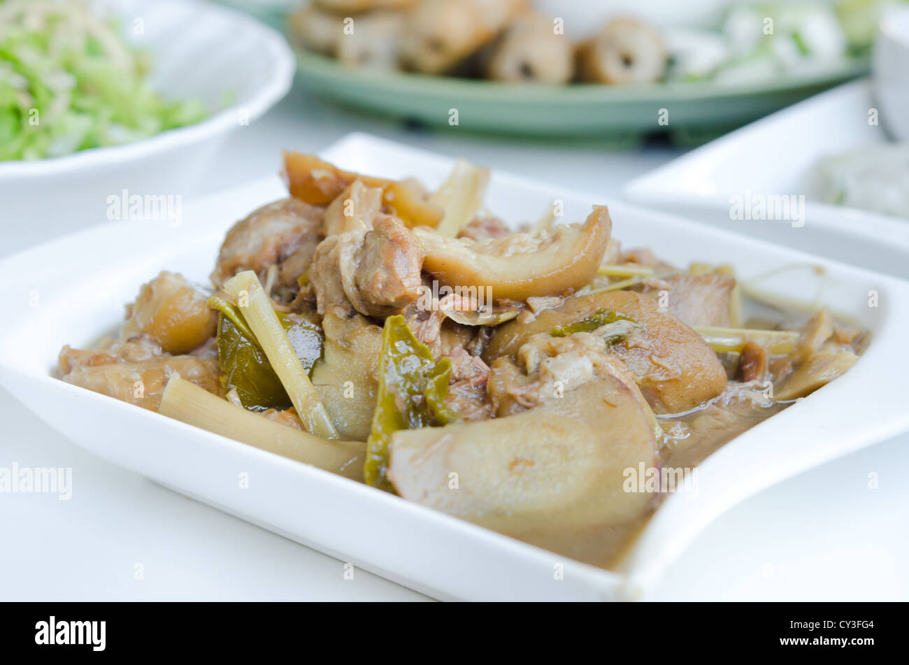 stewed pork knuckle with vegetable and herb on white plate Stock Photo ...