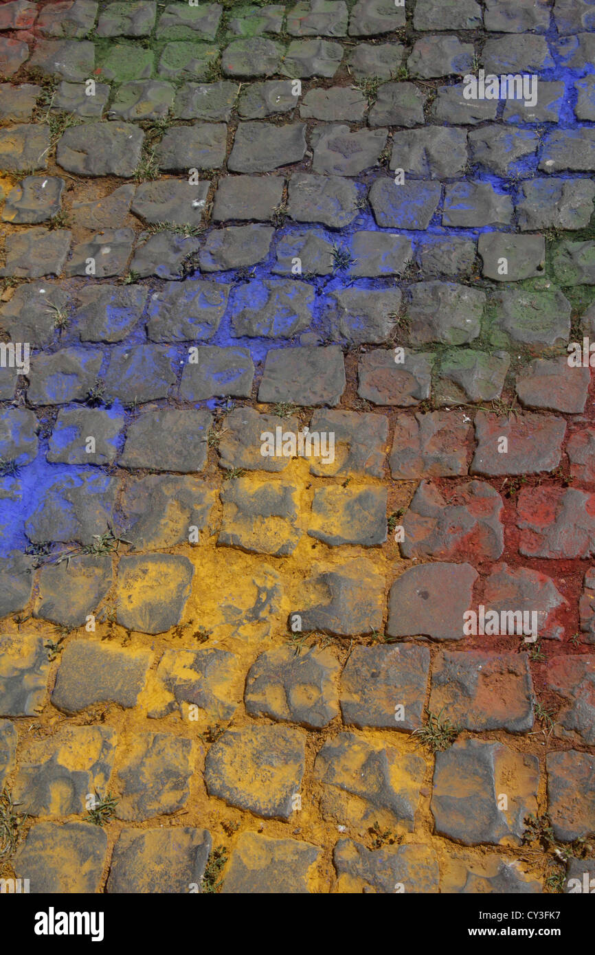 coloured paint on cobble stones in street road surface Stock Photo - Alamy