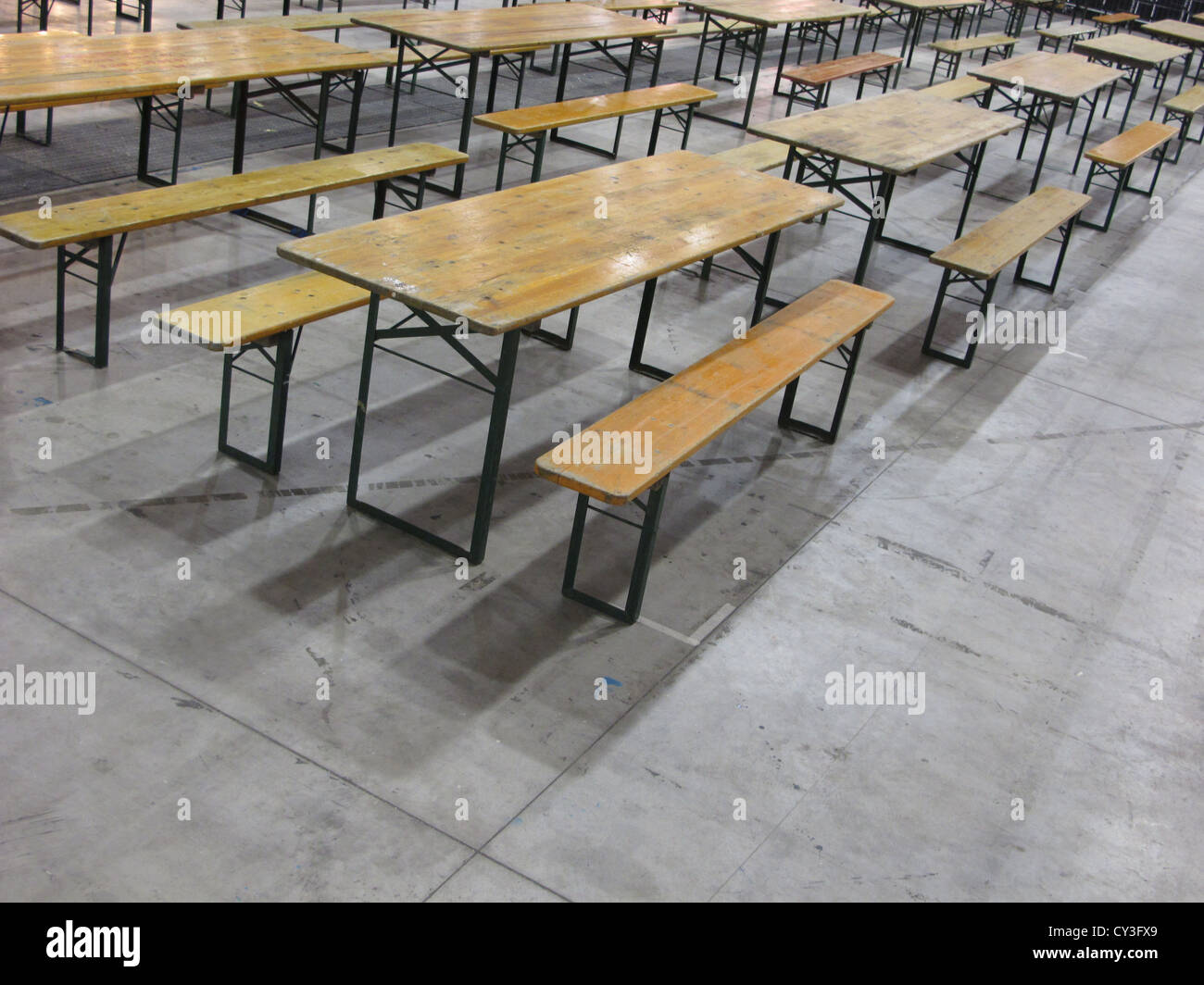 rows of wooden tables and benches in hall Stock Photo - Alamy