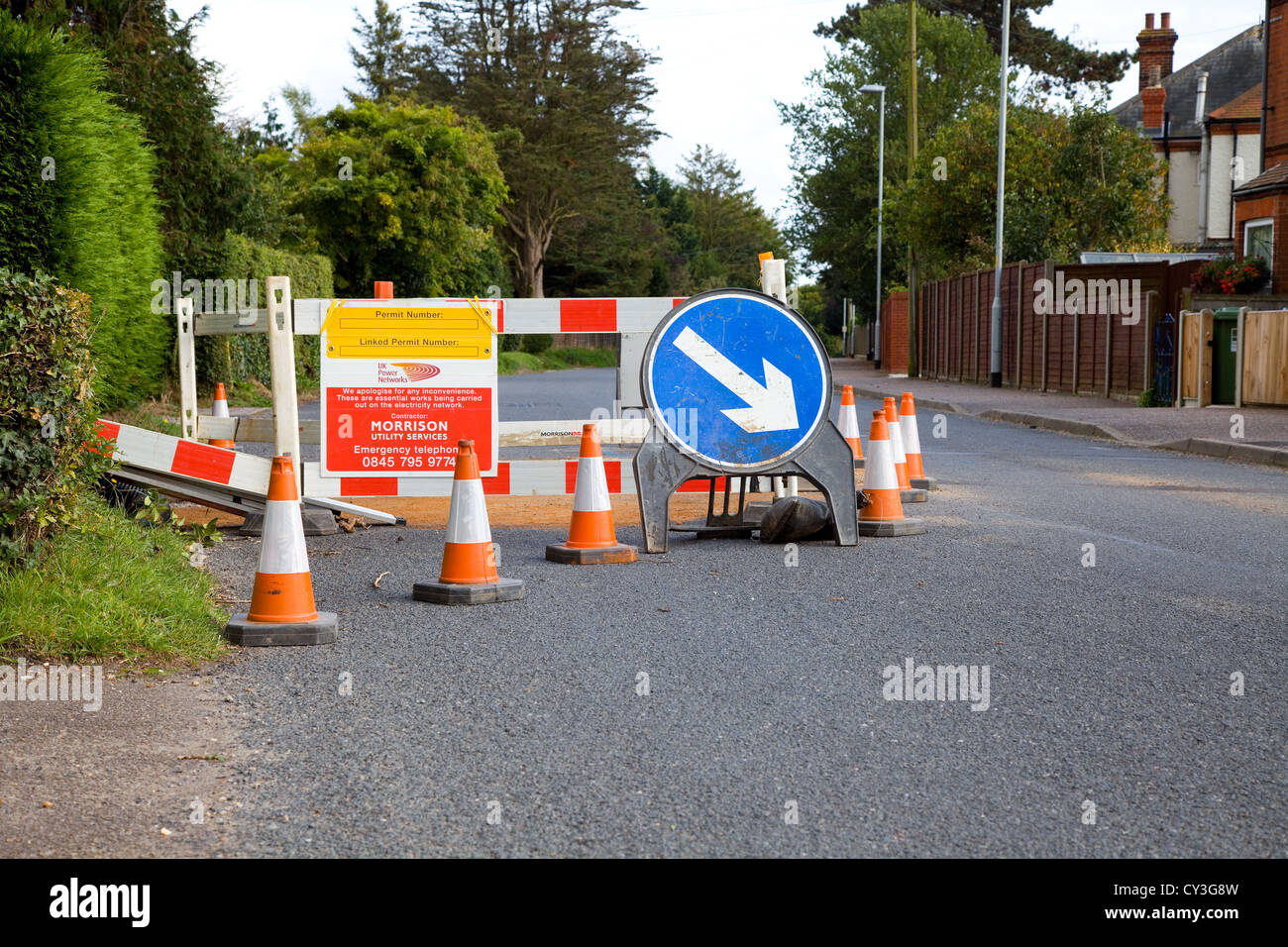 Urban British roadworks & lane closure with cones, watchman barriers ...