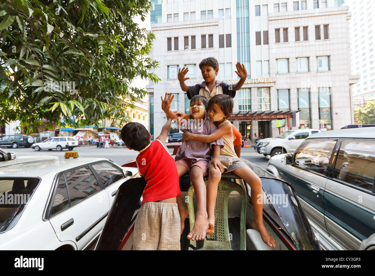 Happy Children sitting on a Car Roof in Rangoon, Myanmar Stock Photo ...