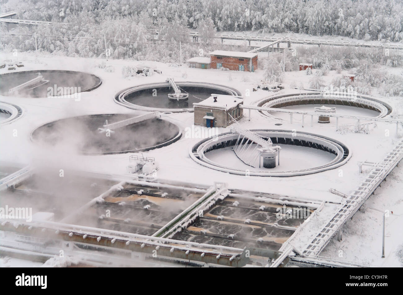 Round sedimentation tanks under snow in winter season Stock Photo - Alamy