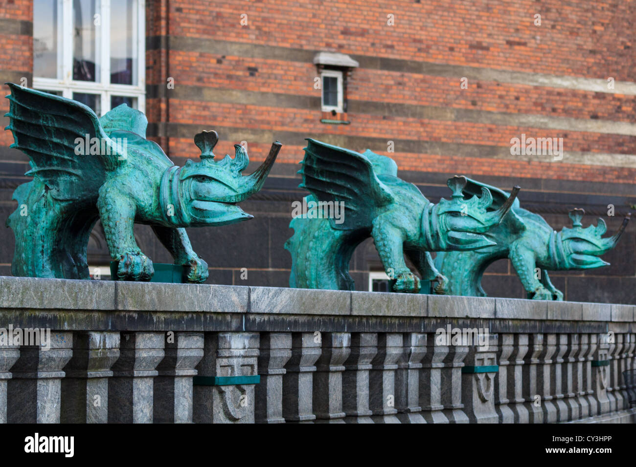 Three bronze dragons in the center of Copenhagen Stock Photo - Alamy