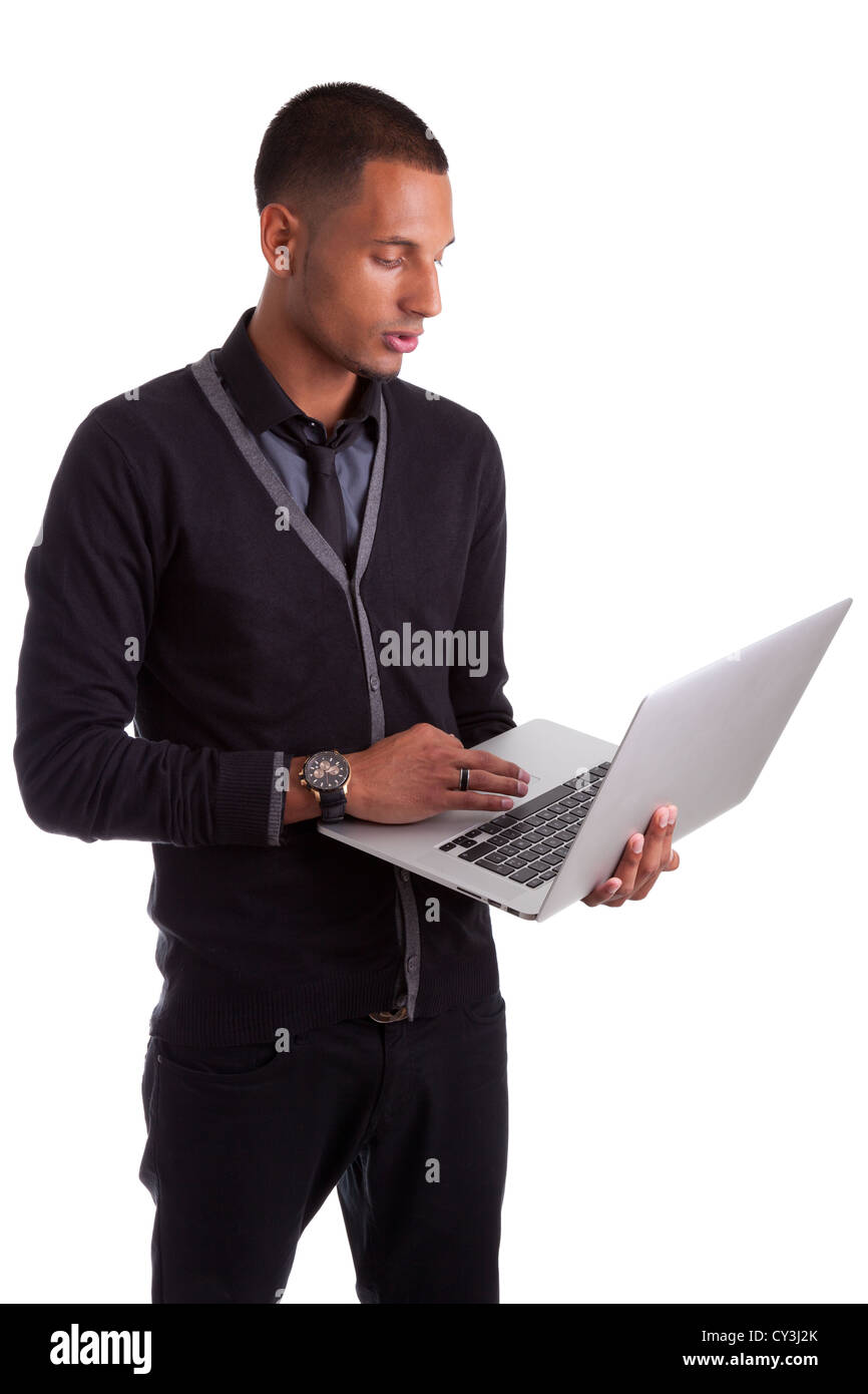 Young african american man using a laptop, isolated on white background ...