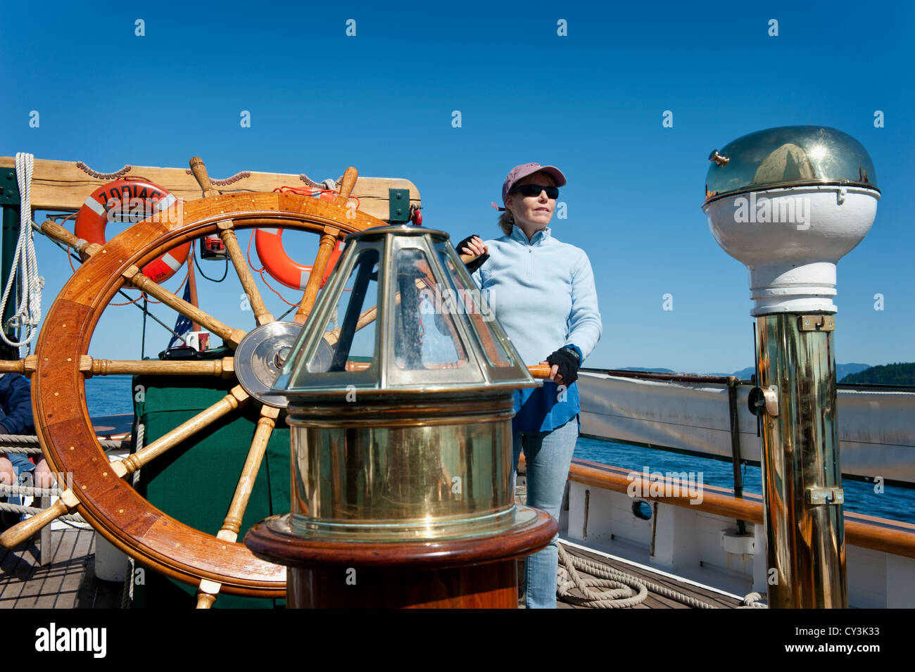 A woman takes the wheel on the historic schooner Zodiac sailing through ...