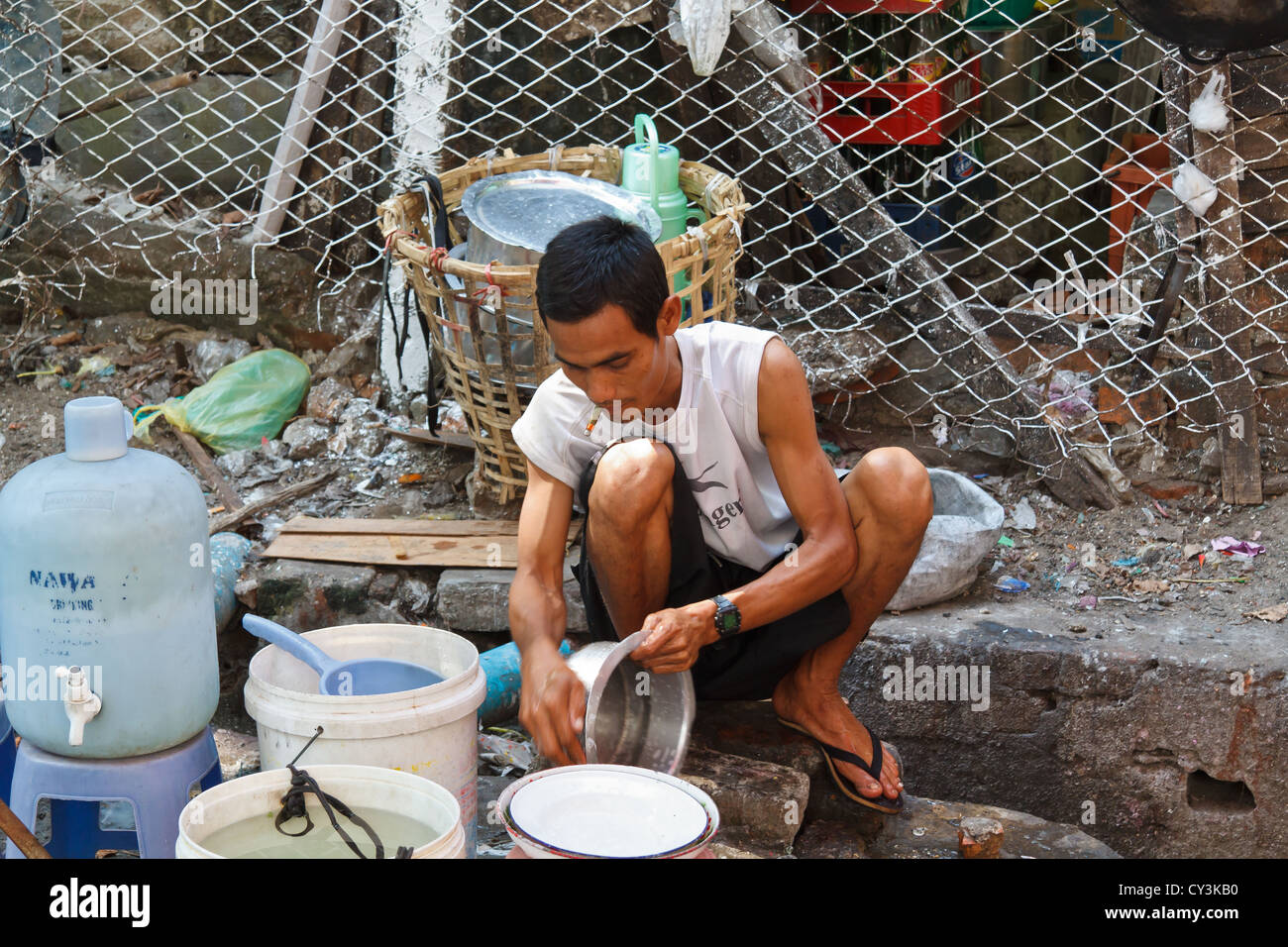 Man washing Dishes in the Street in Rangoon, Myanmar Stock Photo - Alamy