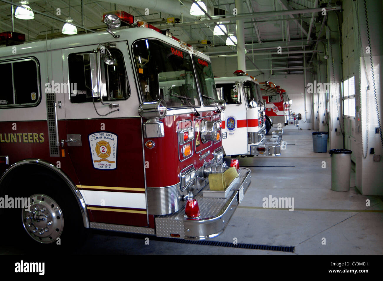 Firetrucks in firehouse Stock Photo - Alamy