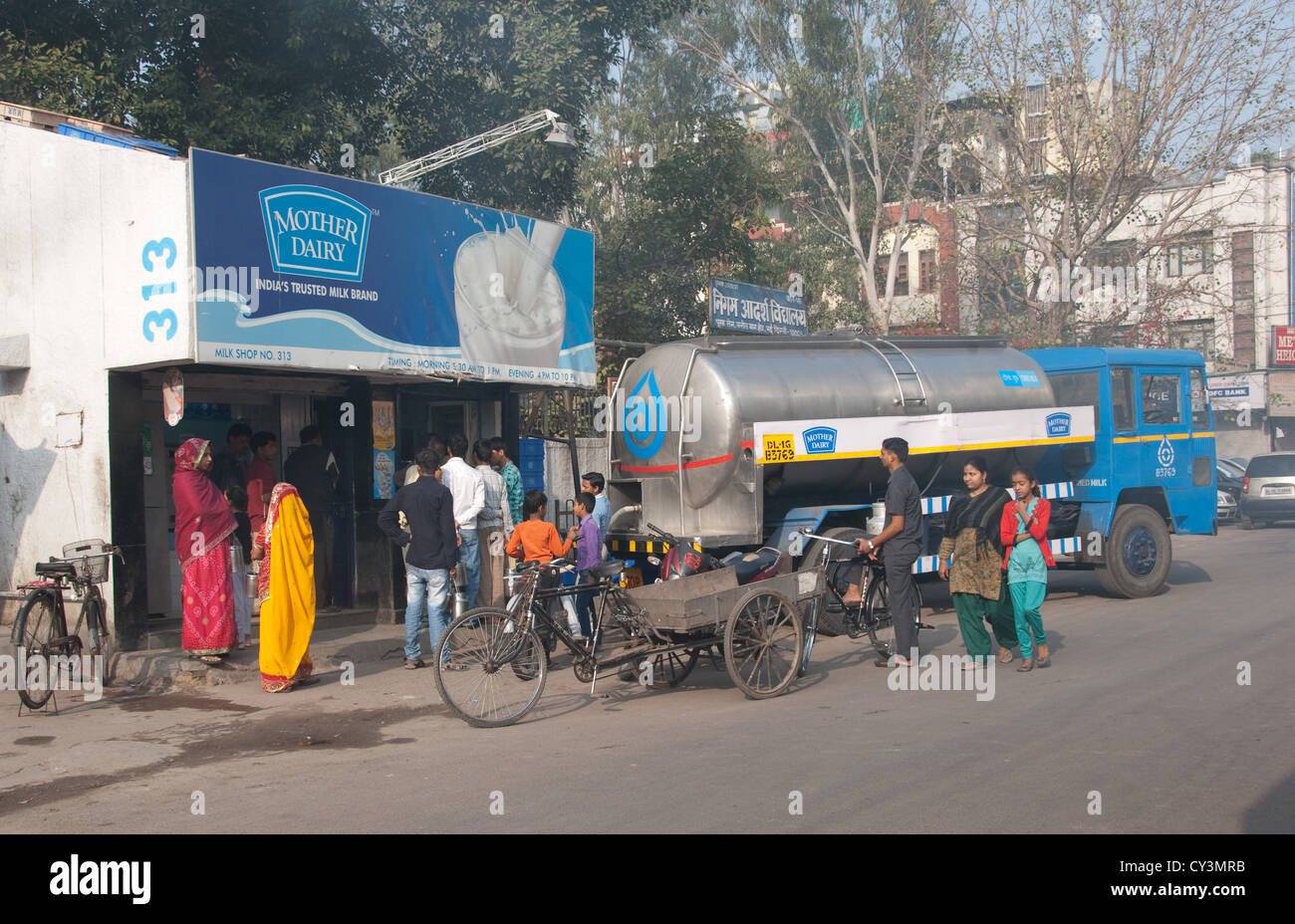 The daily routine. In India people queue to collect fresh milk Stock ...