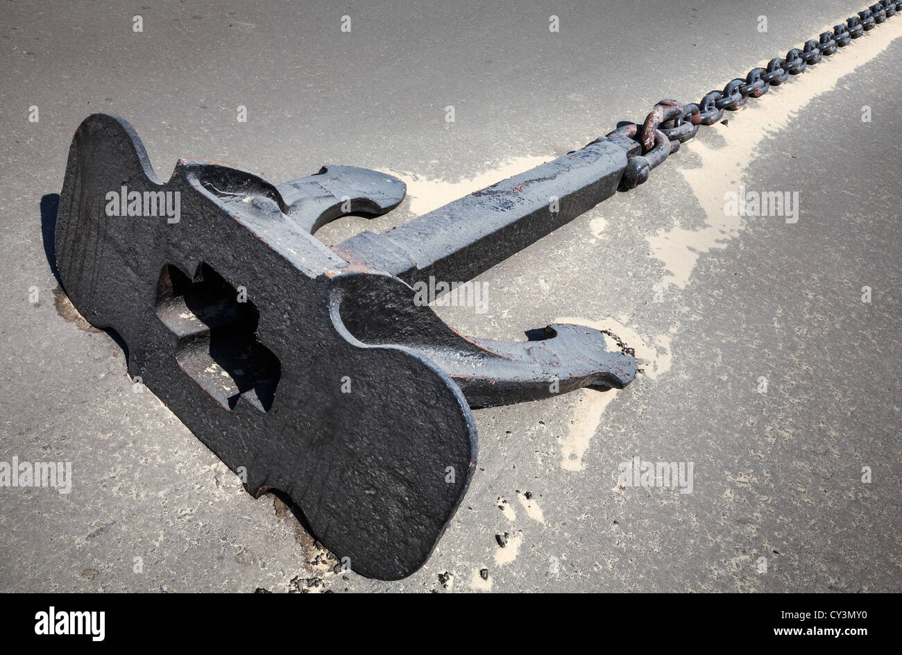 Large ship's mooring anchor with chain on dry ground in the port Stock ...