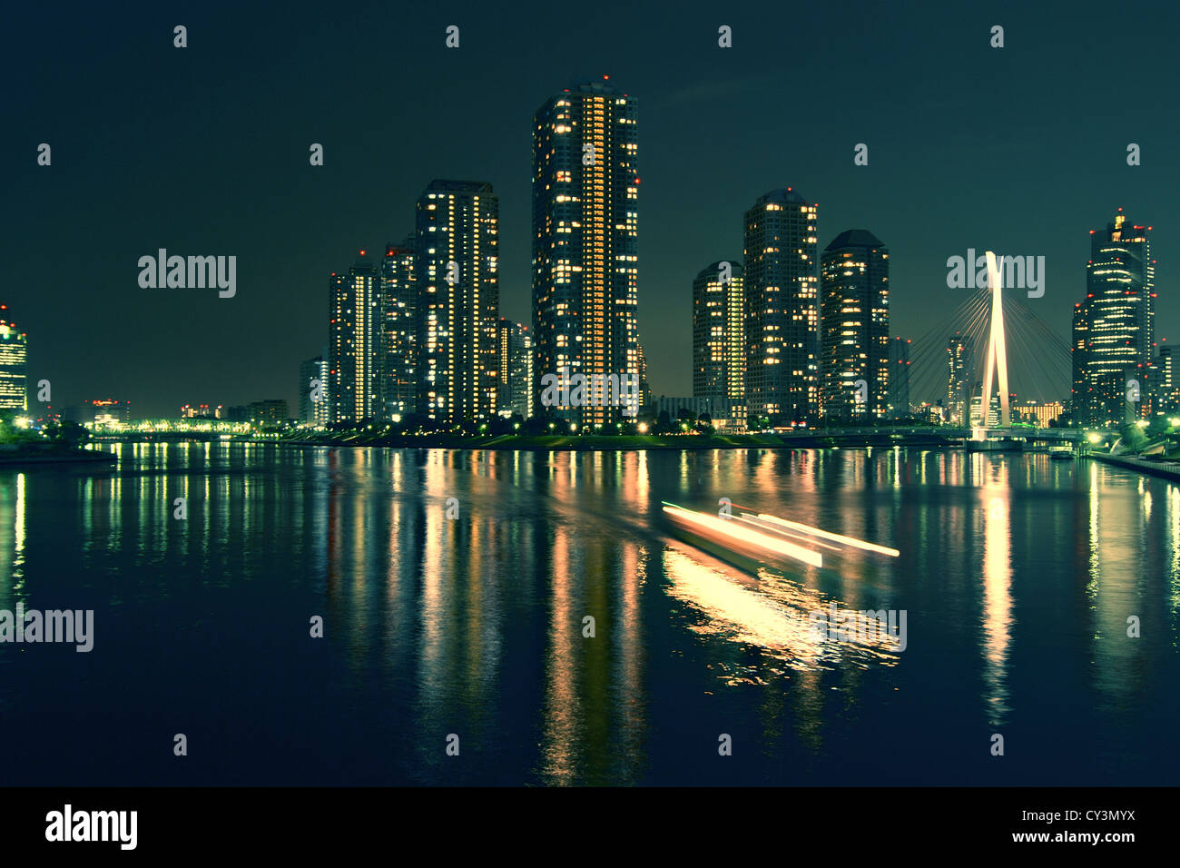 modern Tokyo buildings with night reflection in water and light traces ...