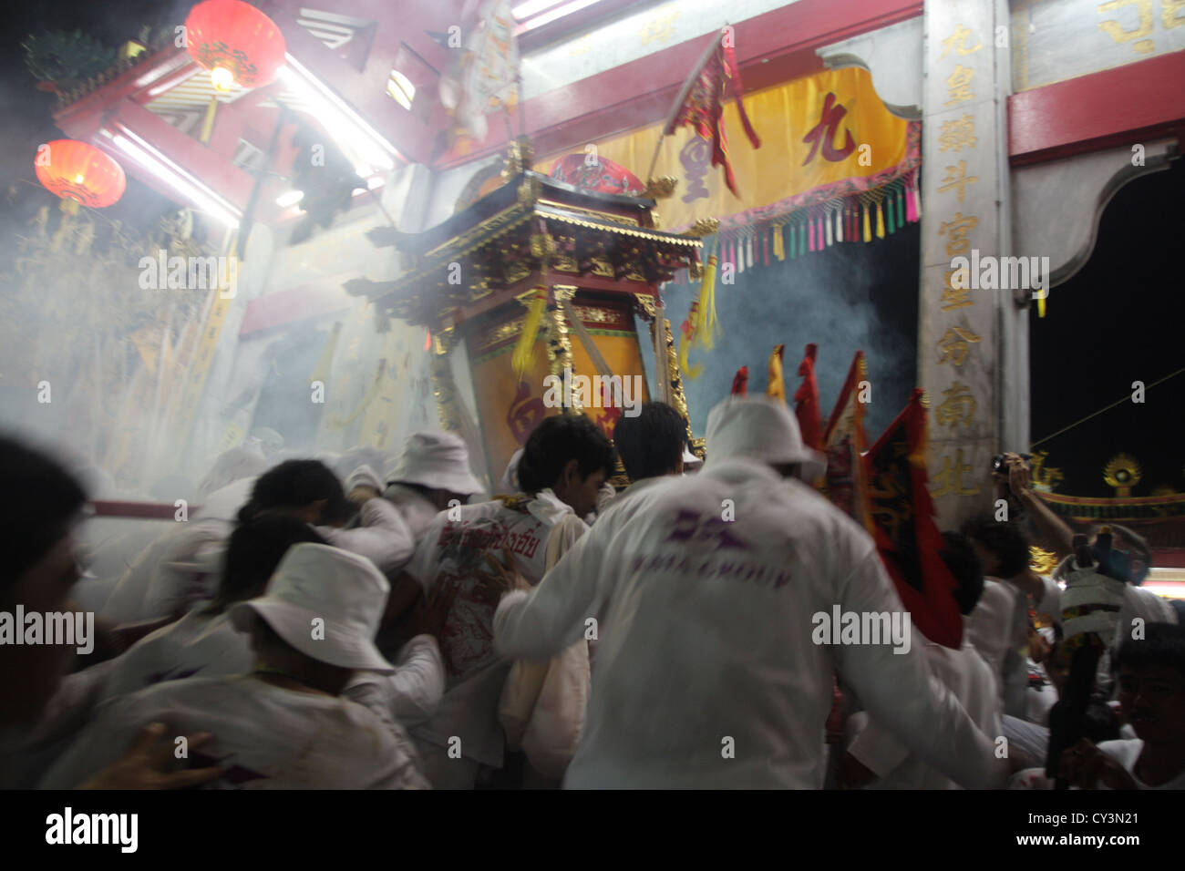 Devotees of the Chinese Shrine carrying an idol on a palanquin during a ...