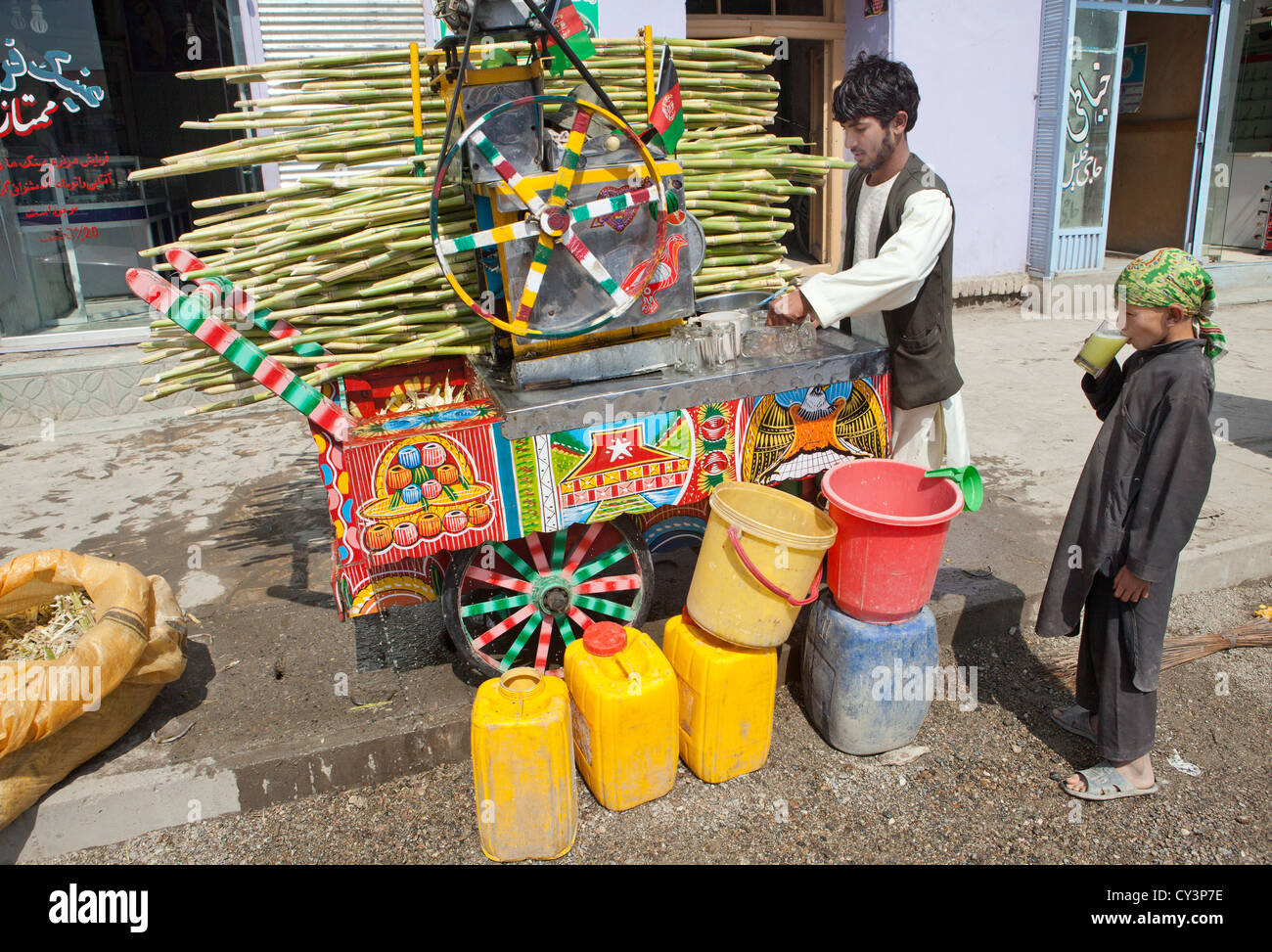 Afghan boy drinks juice made from sugar-cane in kabul Stock Photo - Alamy