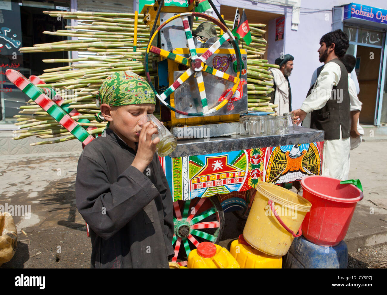 Afghan boy drinks juice made from sugar-cane in kabul Stock Photo - Alamy