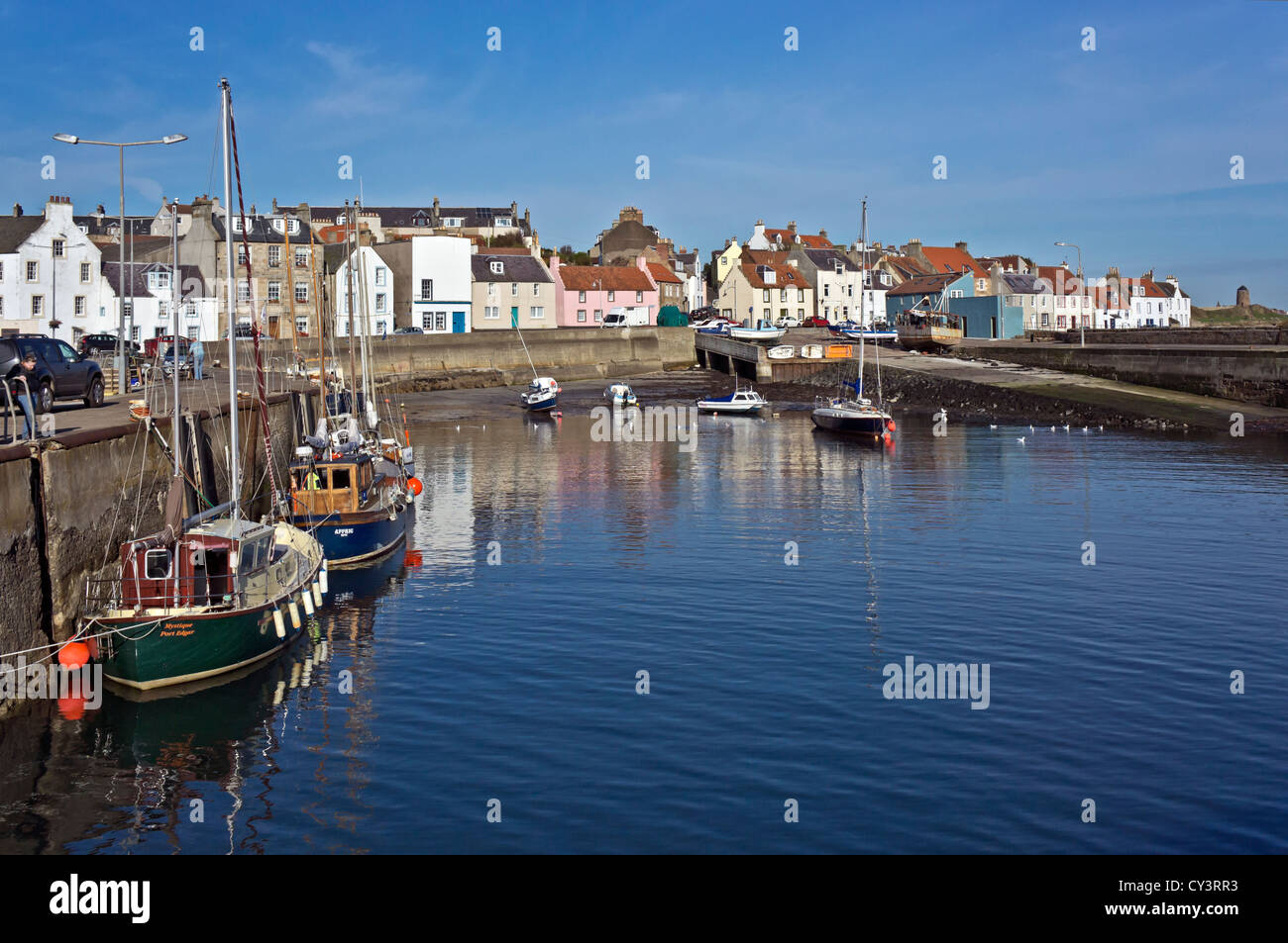 Boats moored in St Monans harbour in the Neuk of Fife Scotland with the ...