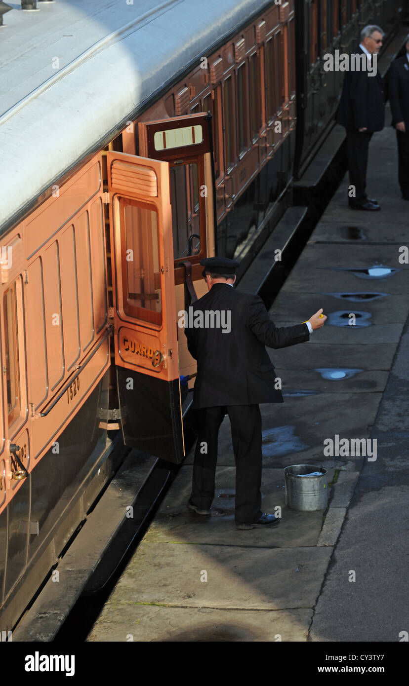 Rail enthusiast cleaning the platform and railway carriages at ...