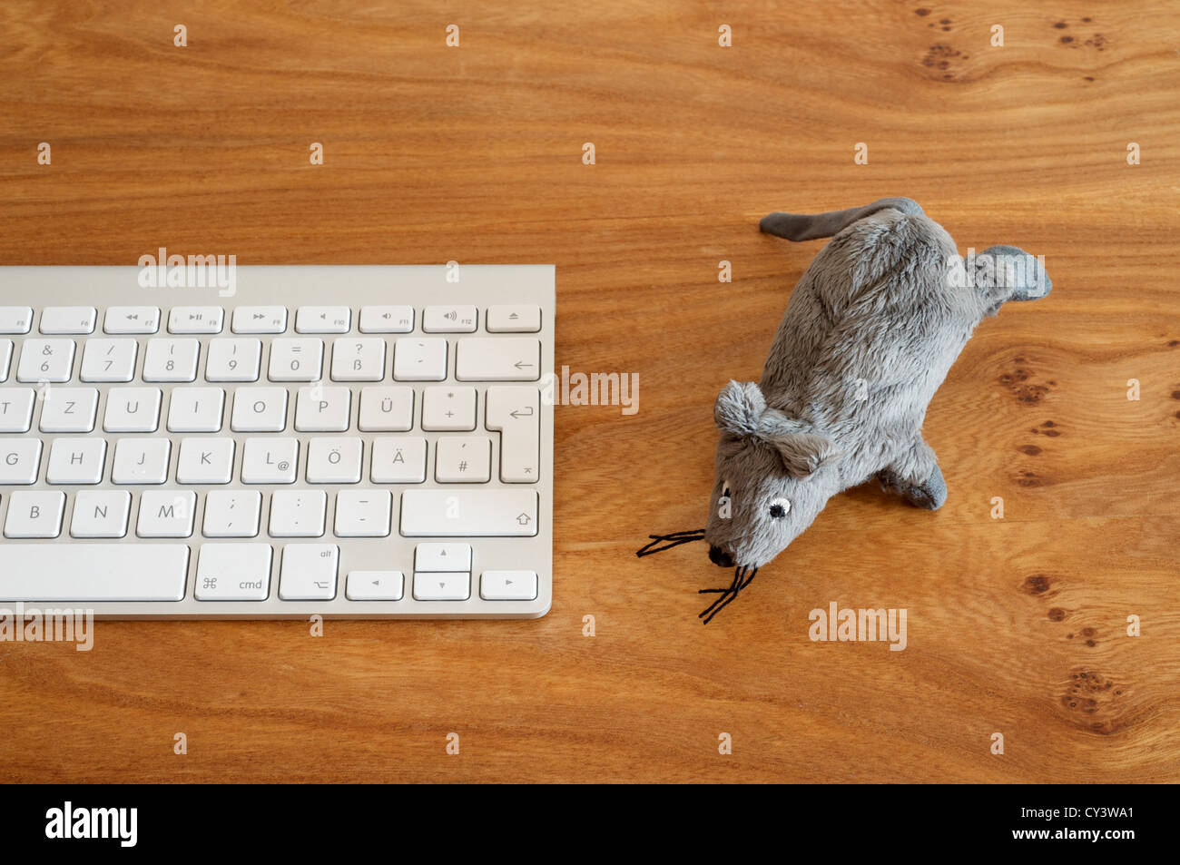 Apple cordless keyboard with fluffy toy mouse Stock Photo - Alamy