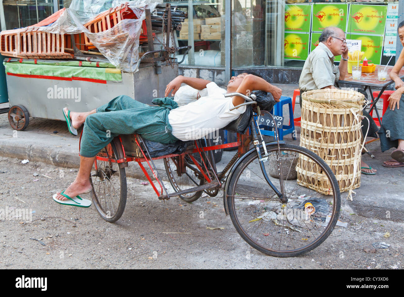 Sleeping Rickshaw Driver in Rangoon, Myanmar Stock Photo - Alamy