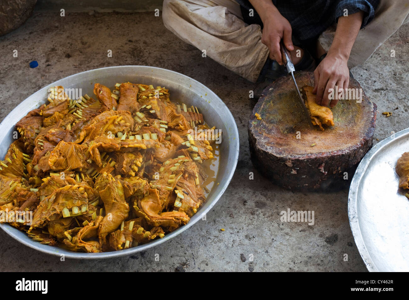 A Waza or chef in the Kashmiri tradition chops lamb ribs for a dish ...