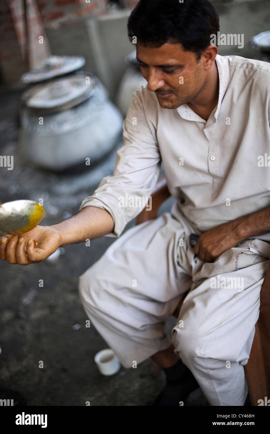 A Waza or cook in the Kashmiri traditions tastes food for a traditional ...