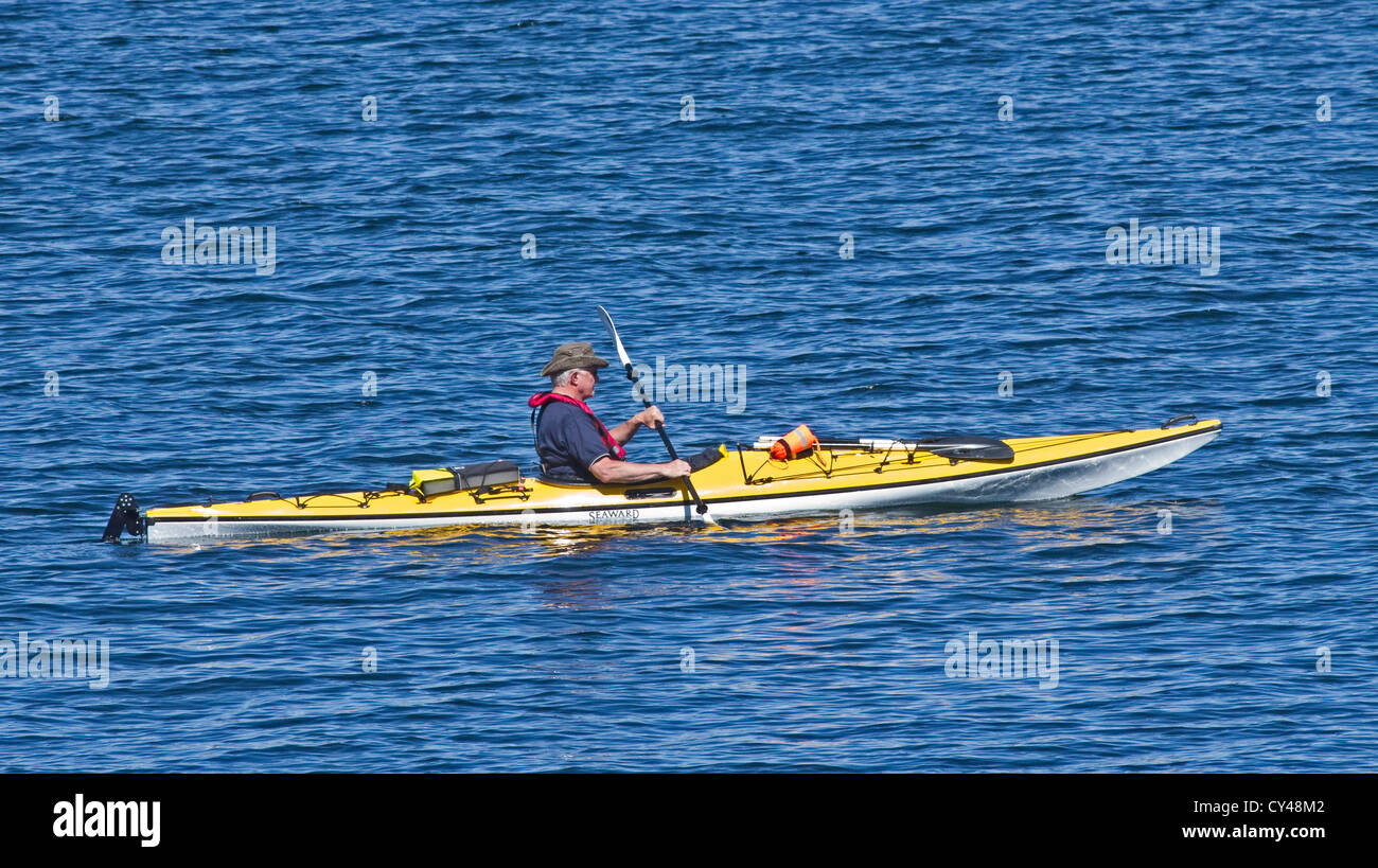 Elderly man in a sea going Kayak Stock Photo - Alamy