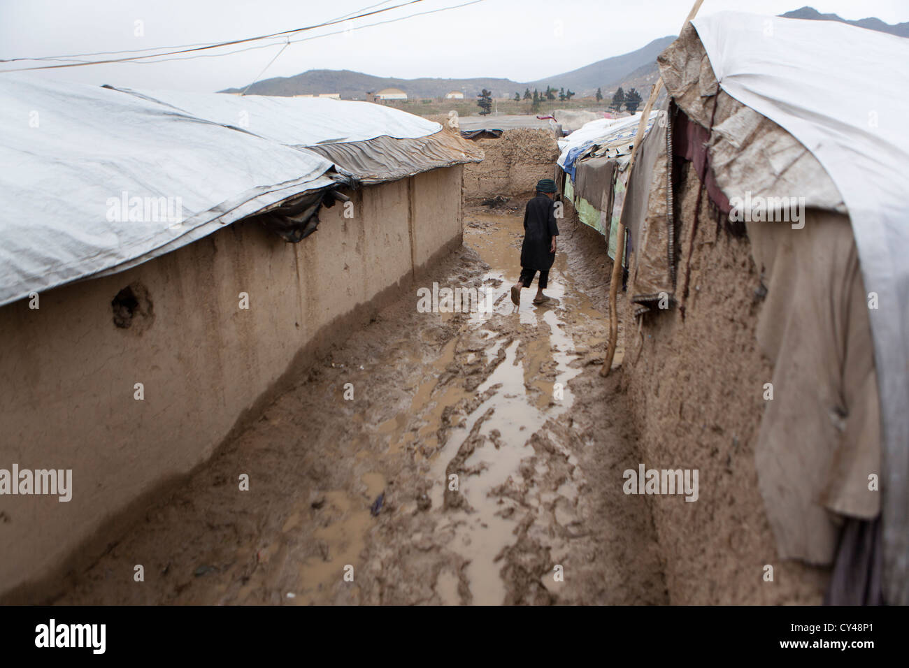 Afghan boy walking in a slum of kabul Stock Photo - Alamy