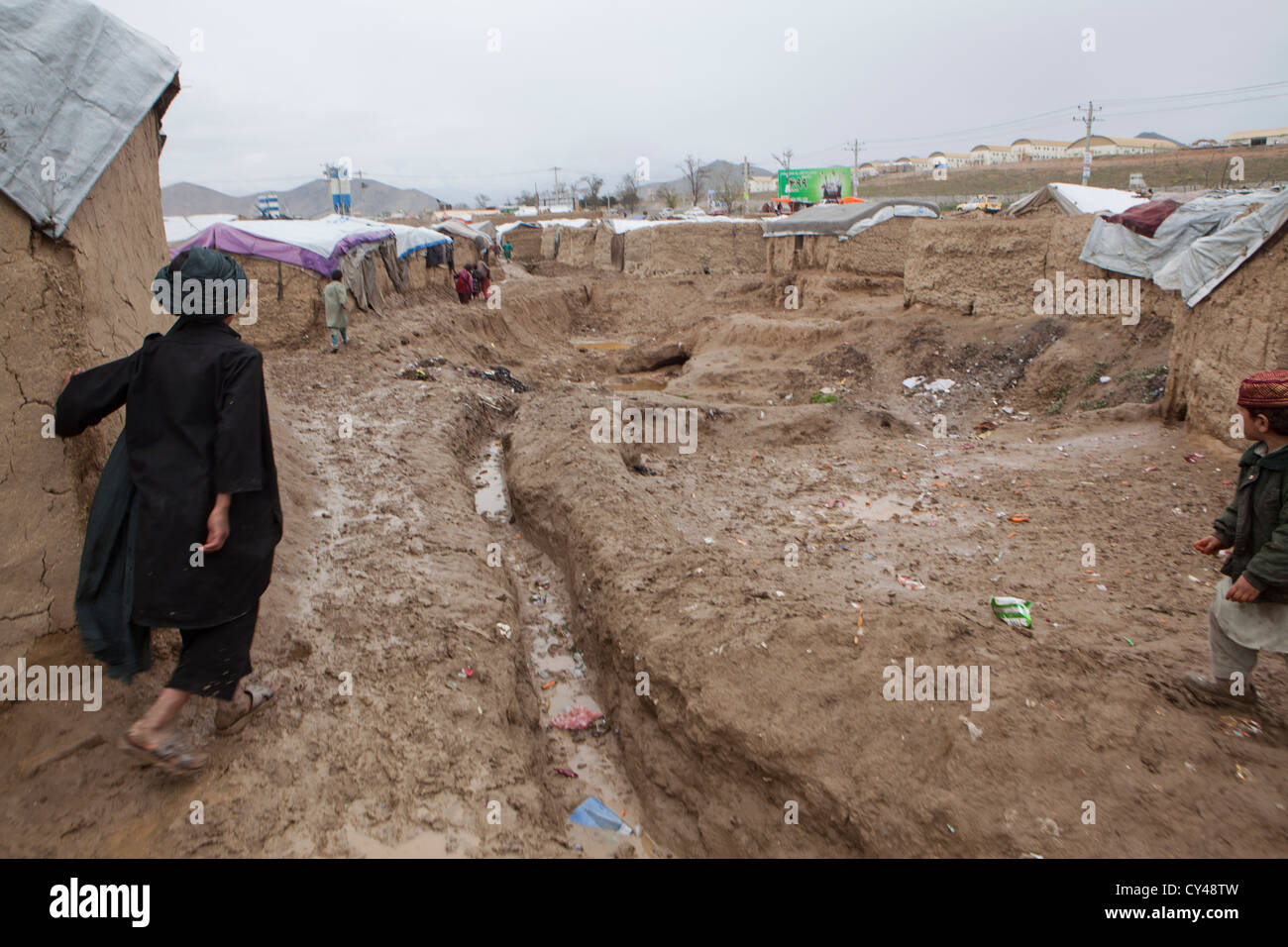 Afghan boy walking in a slum of kabul Stock Photo - Alamy