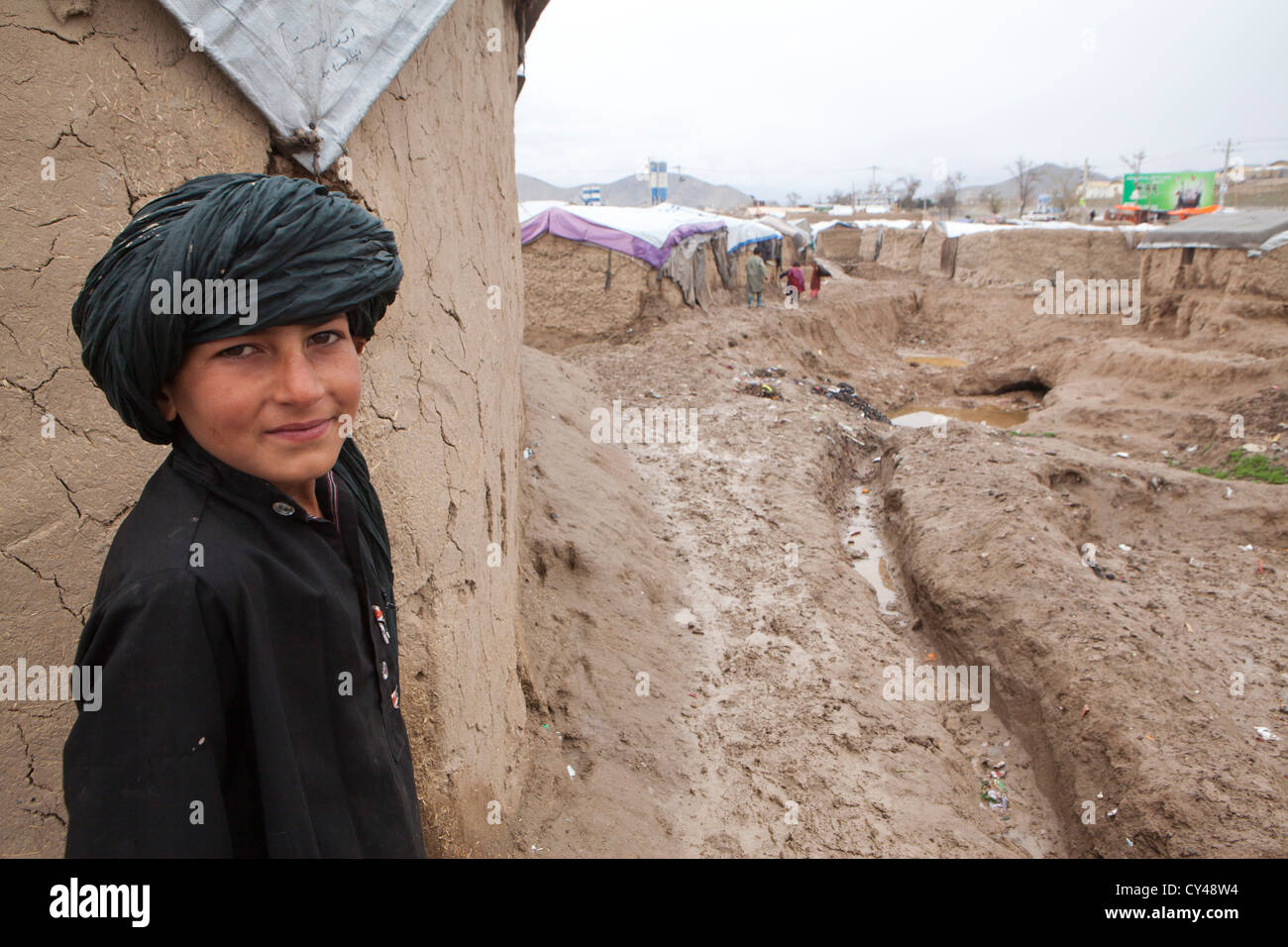 Afghan boy walking in a slum of kabul Stock Photo - Alamy
