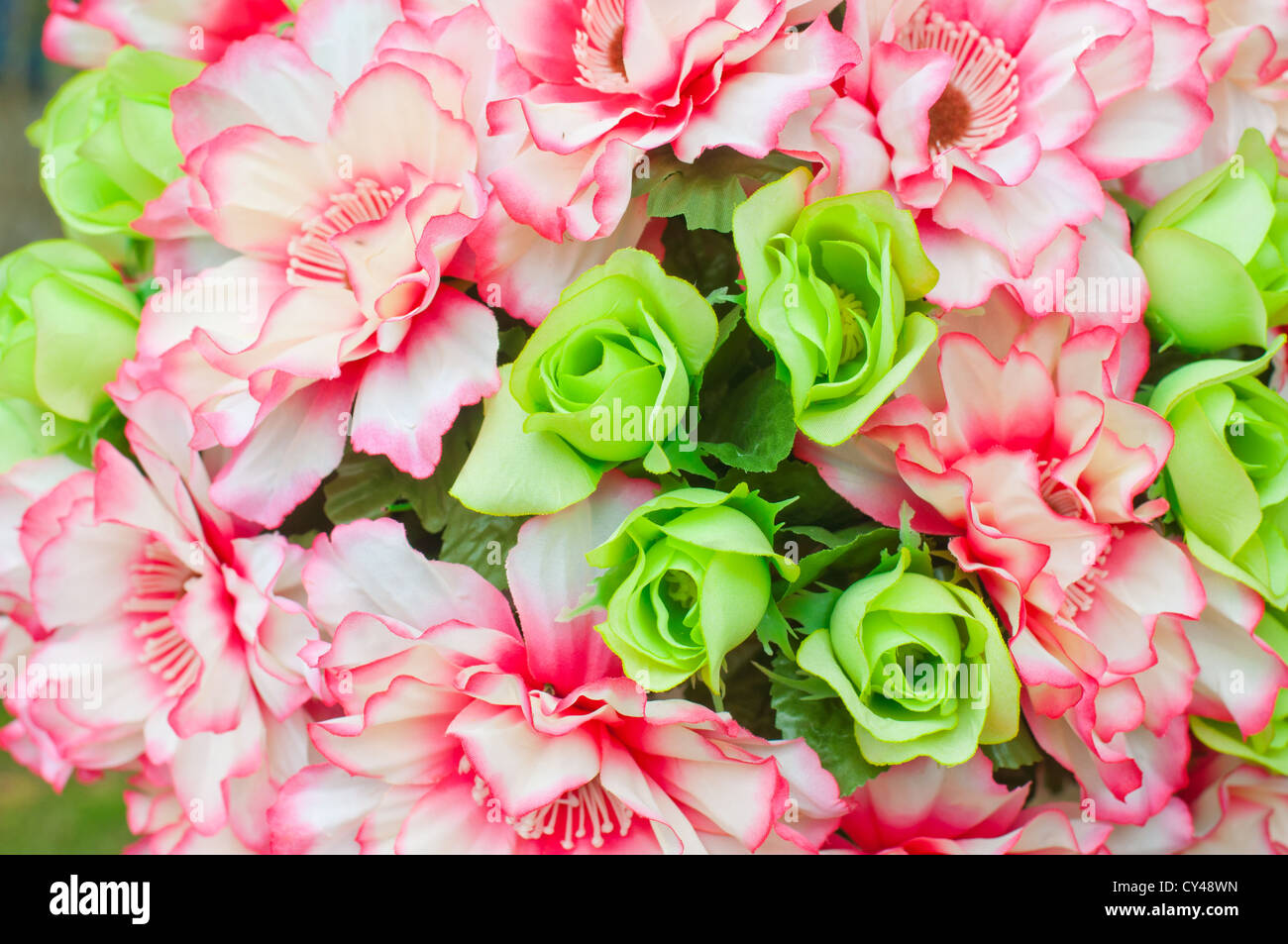 Artificial flowers background Stock Photo - Alamy