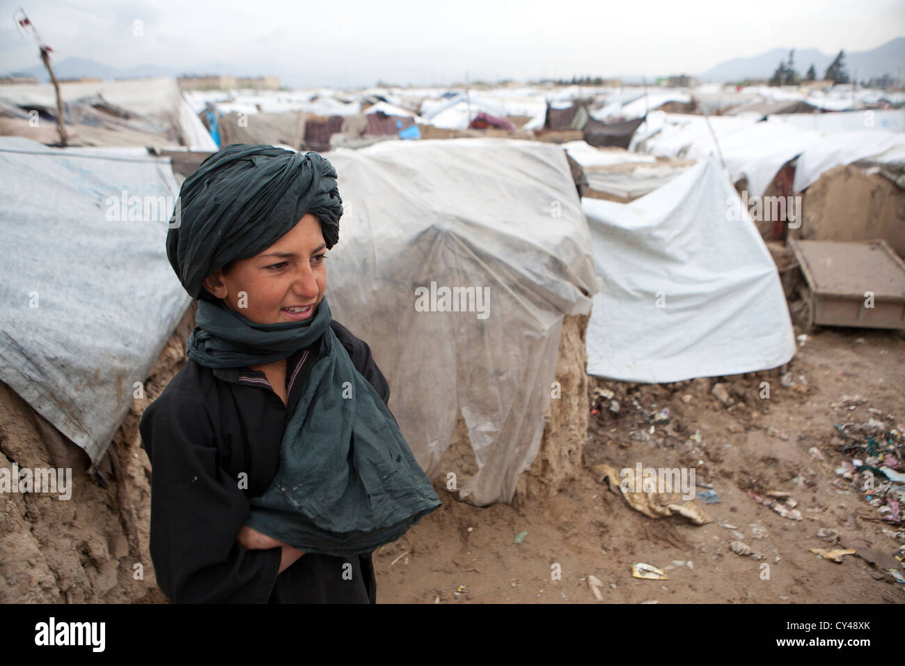 Afghan boy walking in a slum of kabul Stock Photo - Alamy