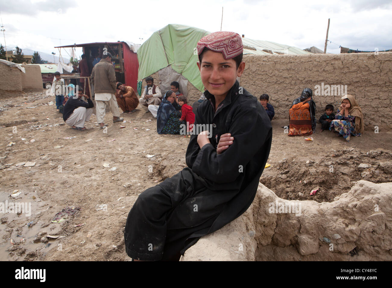 Afghan boy walking in a slum of kabul Stock Photo - Alamy