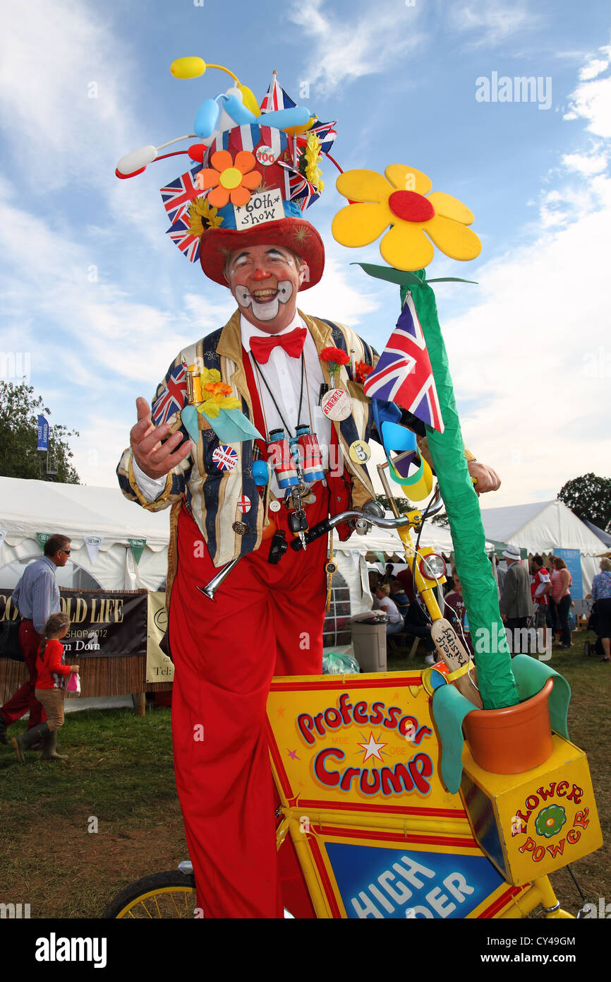 Colorful Professor Crump wearing top hat on bicycle with sunflower ...