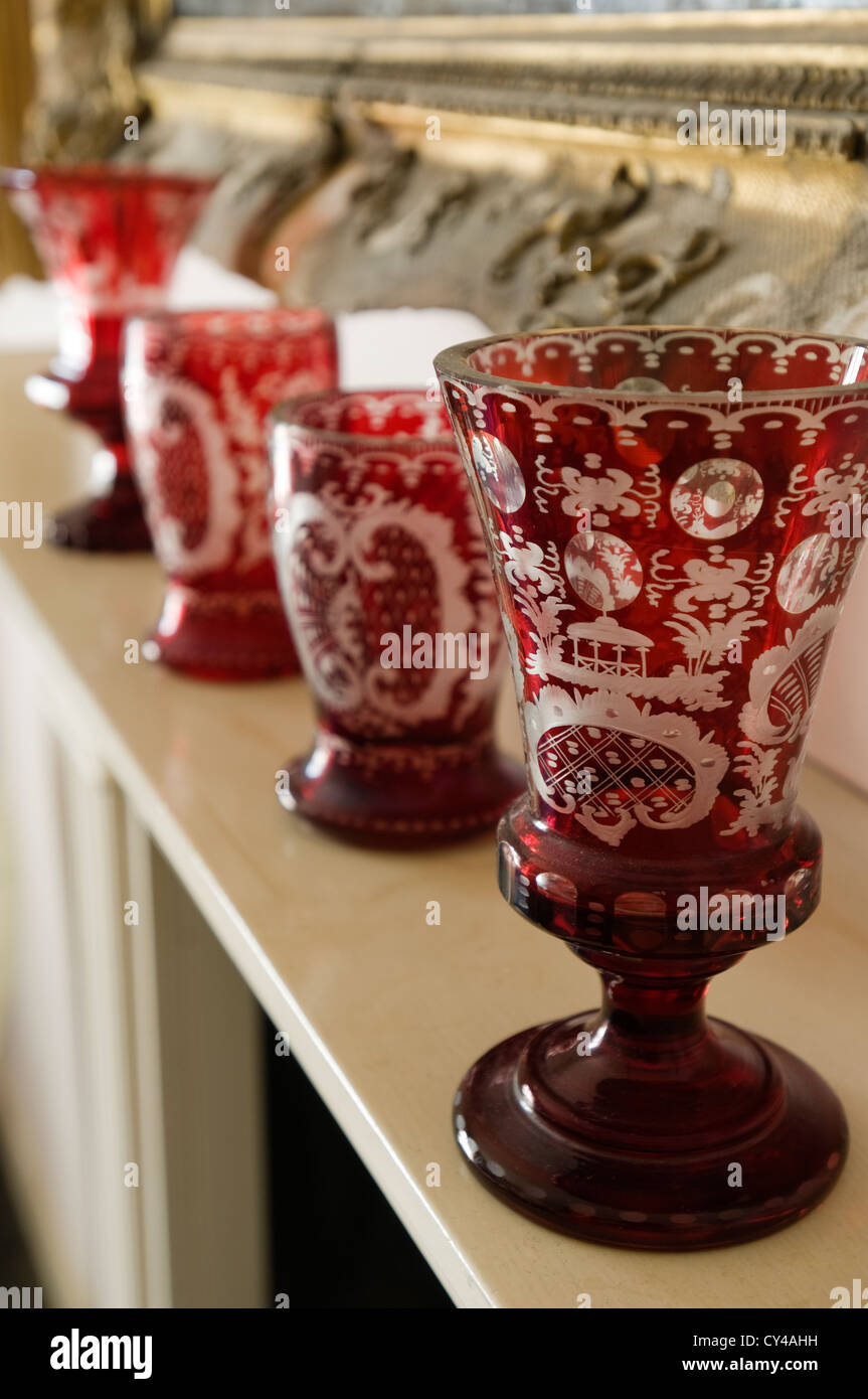 Red cut glass goblets on mantelpiece Stock Photo - Alamy