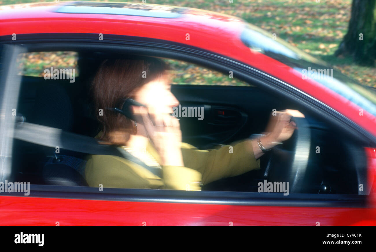 Using a mobile phone whilst driving a car Stock Photo - Alamy