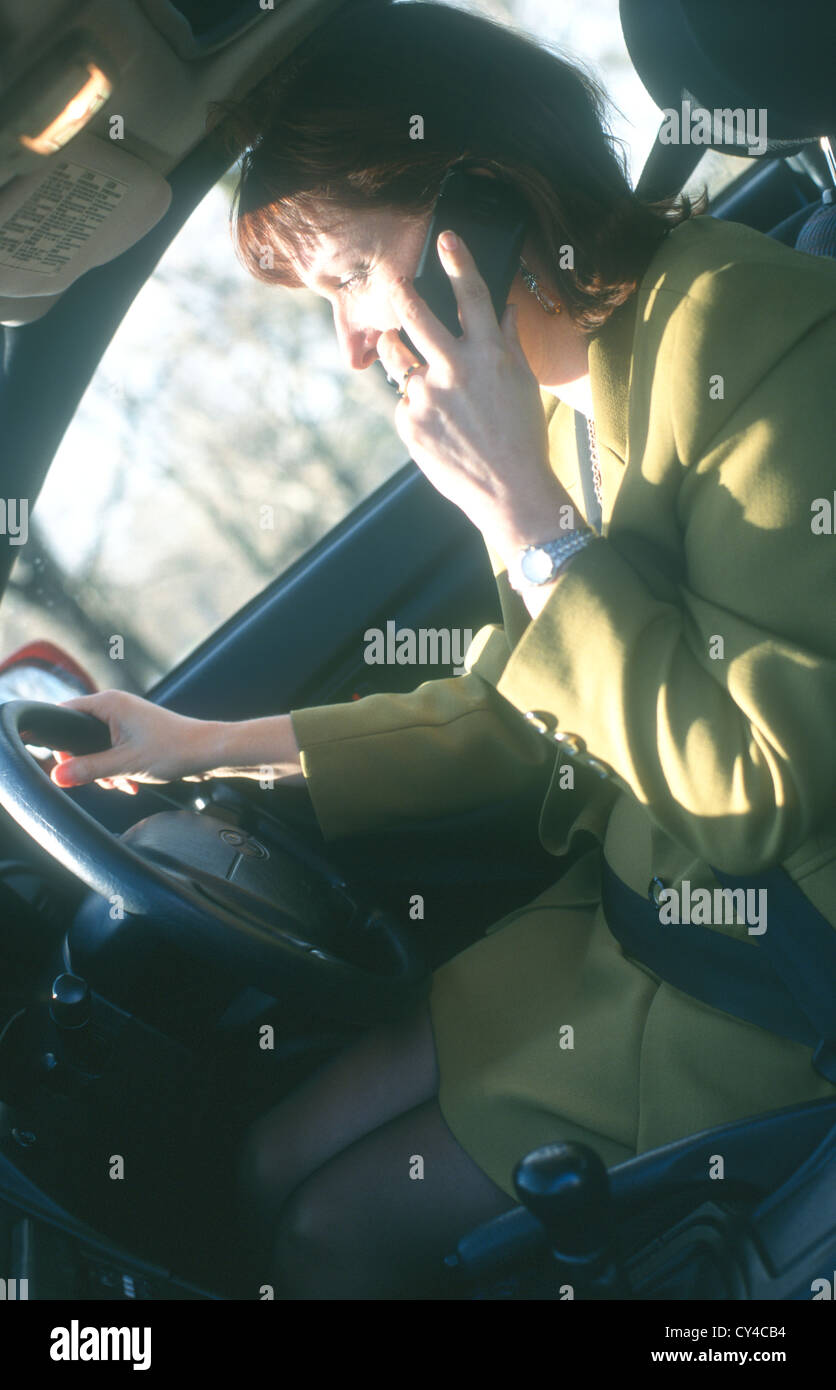 Woman driving whilst using mobile phone hi-res stock photography and ...