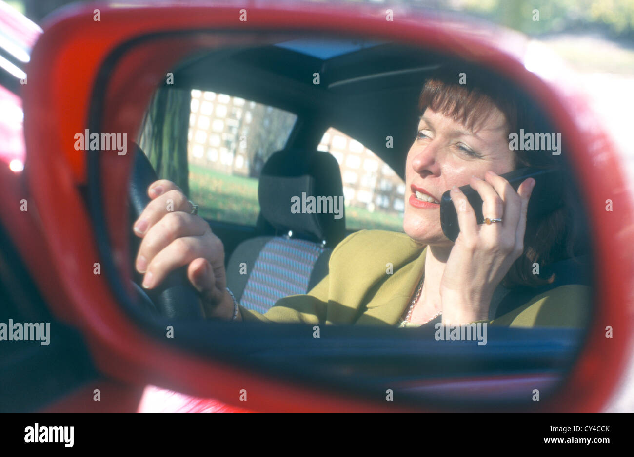 Using a mobile phone whilst driving a car Stock Photo - Alamy