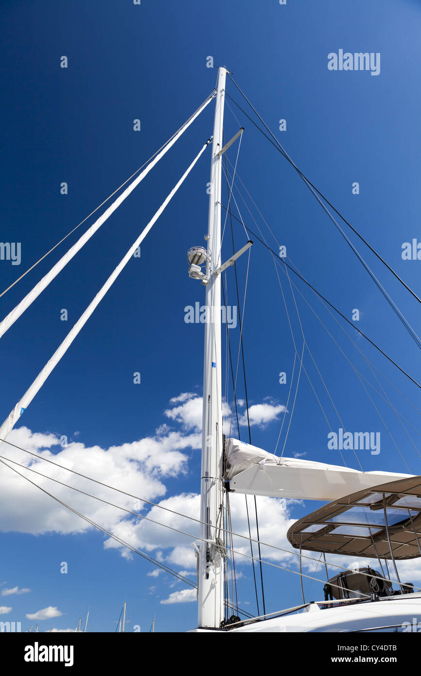 Detail view of a large catamaran sailing boat in front of a blue sky ...