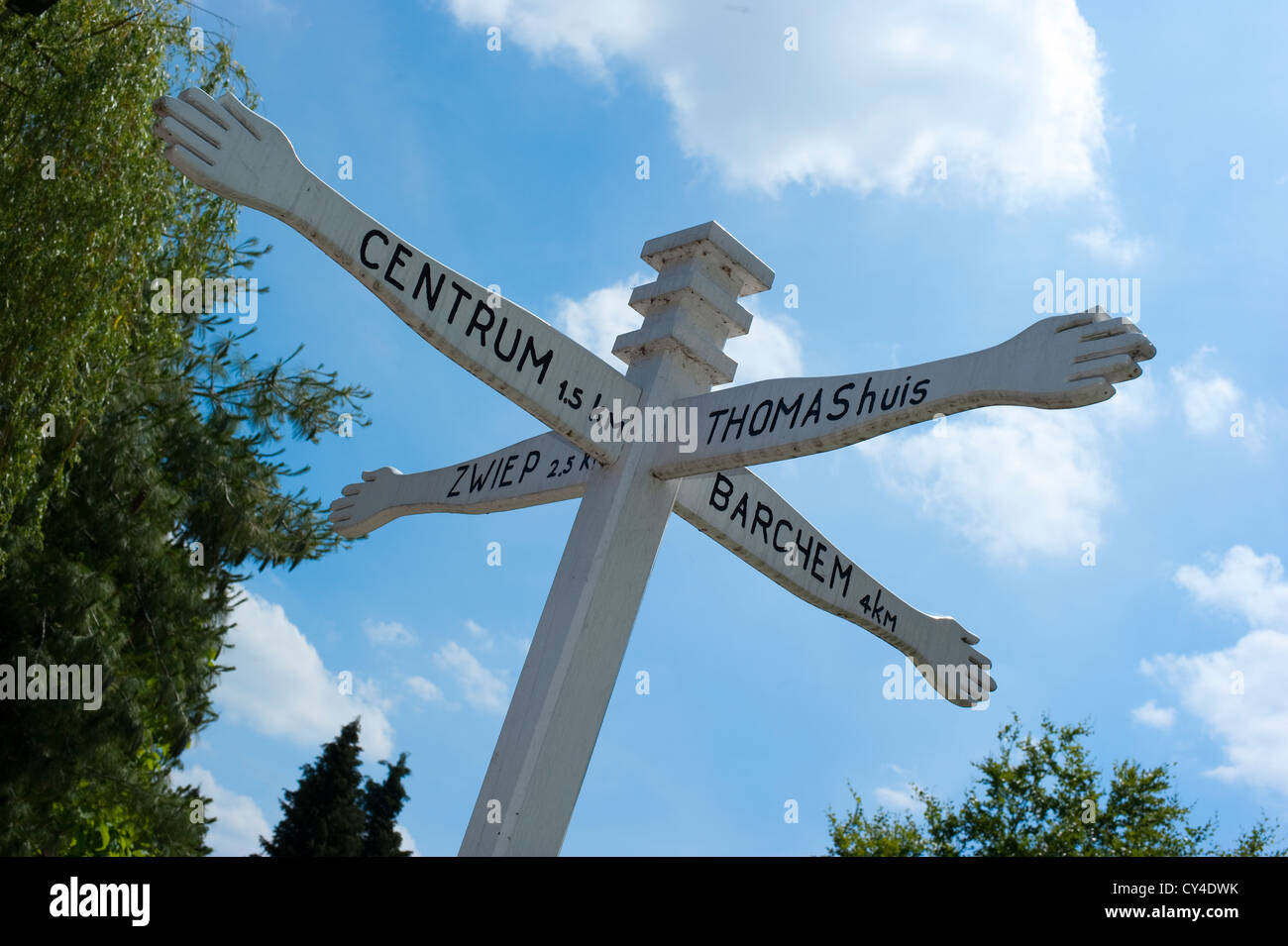 Direction sign with hands pointing in four directions Stock Photo - Alamy