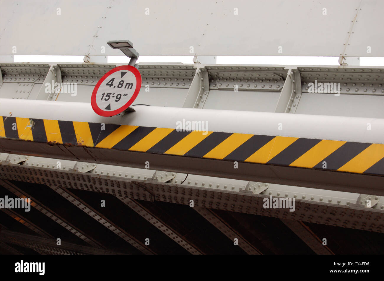 Low railway bridge with black and yellow markings Stock Photo - Alamy