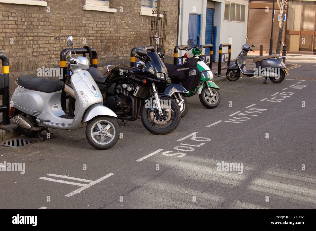 Row of mopeds parked in a side street in London, England Stock Photo ...