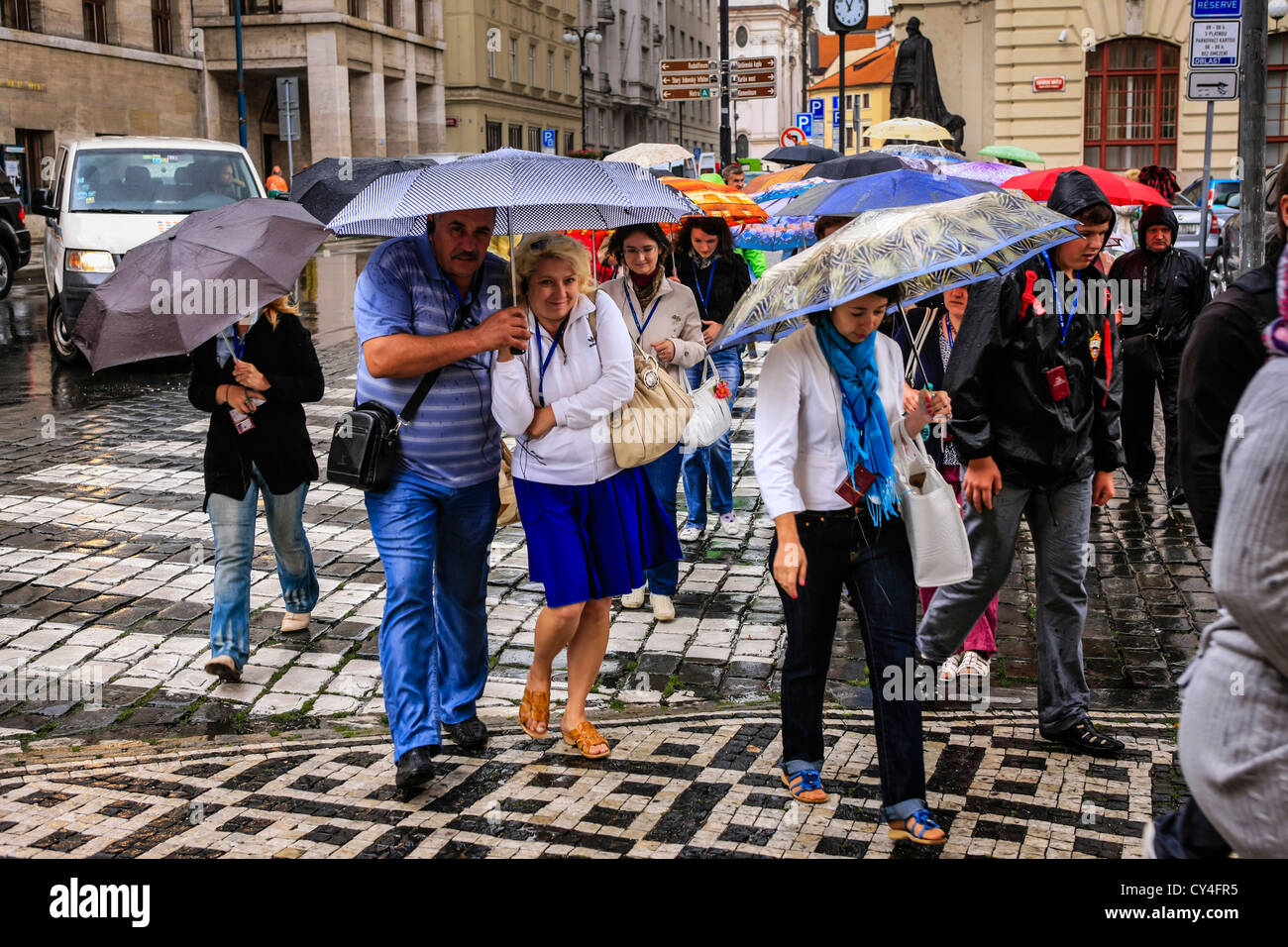 Foreign tourists sightseeing in the rain thru Prague Stock Photo - Alamy