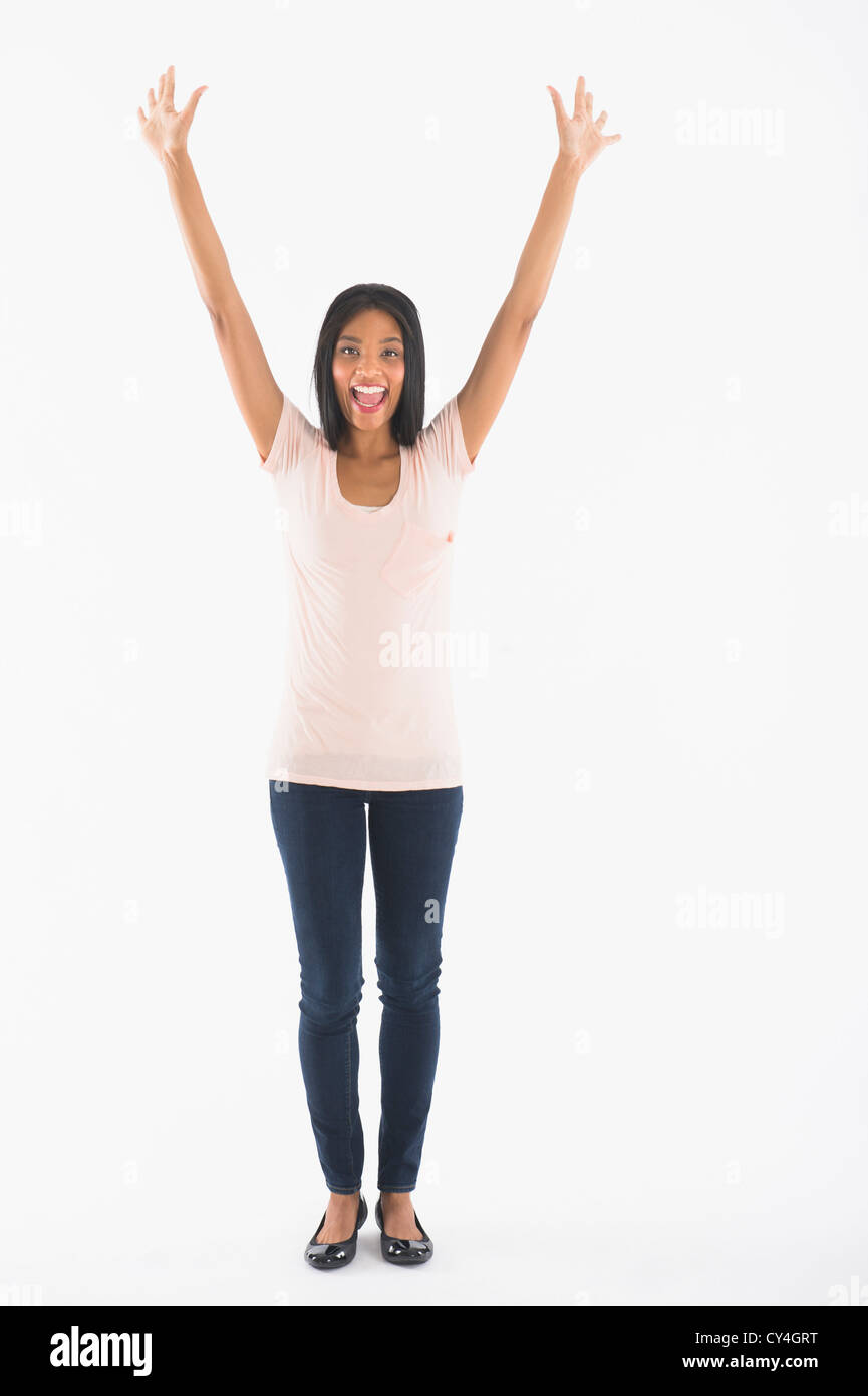 Portrait of woman with arms up, studio shot Stock Photo - Alamy
