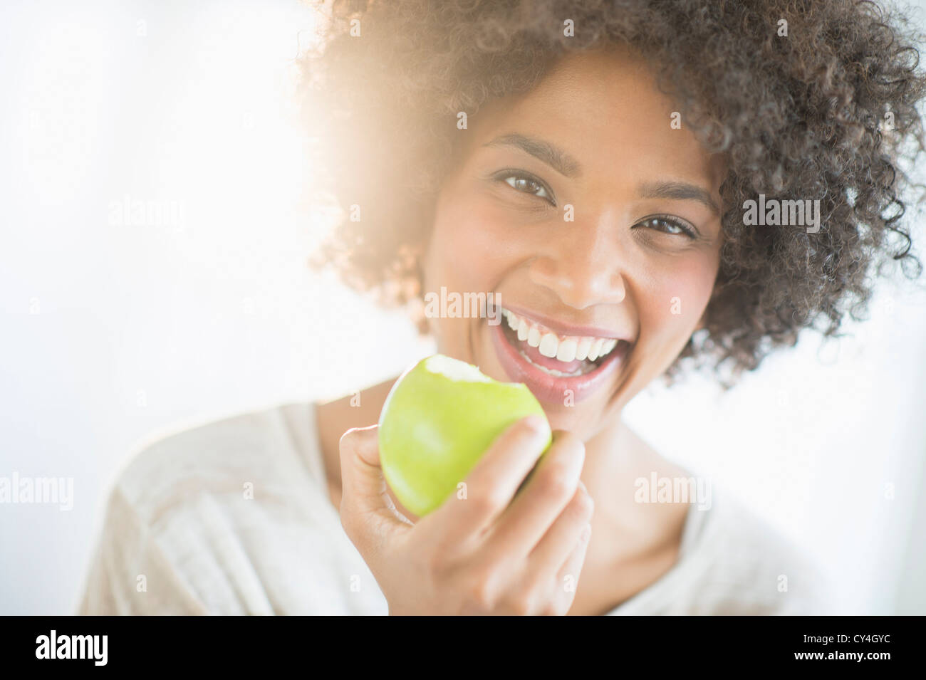 Portrait of woman eating apple, studio shot Stock Photo - Alamy