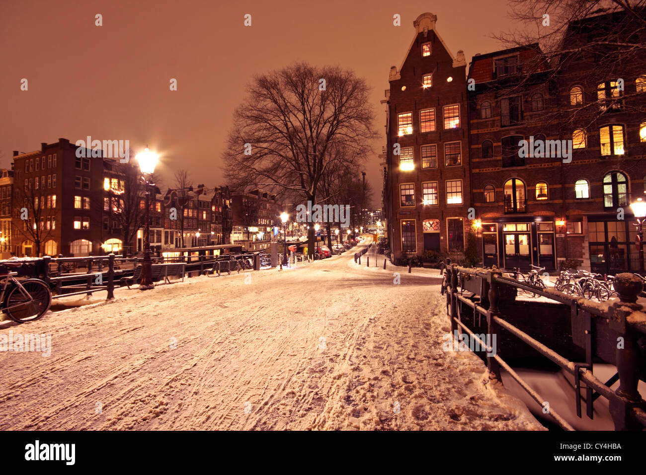 Cityscenic from Amsterdam covered with snow in the Netherlands at night ...