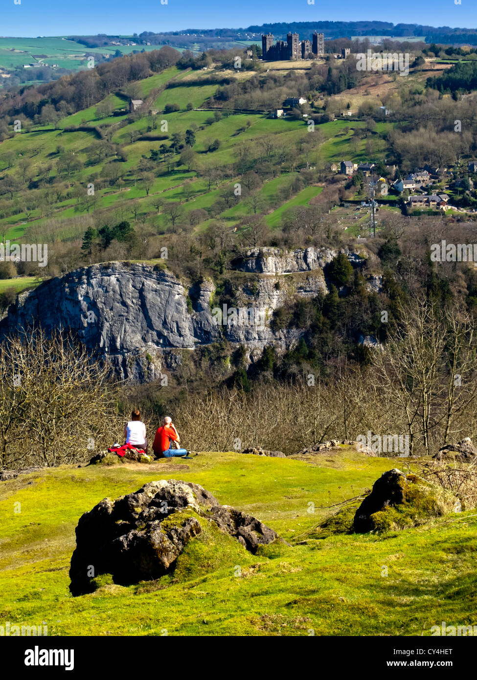 Couple enjoying view across the River Derwent Gorge towards High Tor ...
