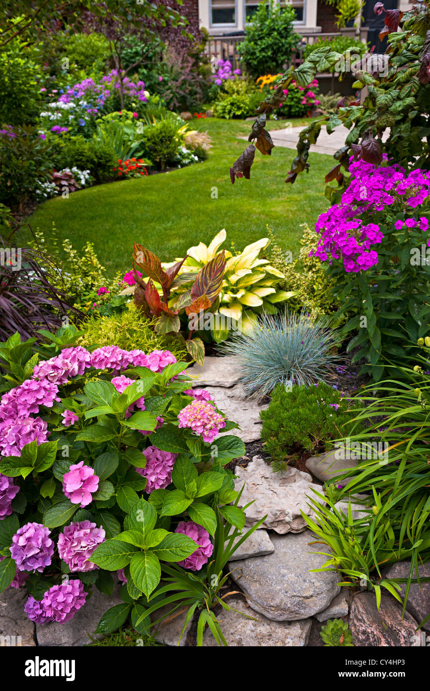 Lush landscaped garden with flowerbed and colorful plants Stock Photo ...