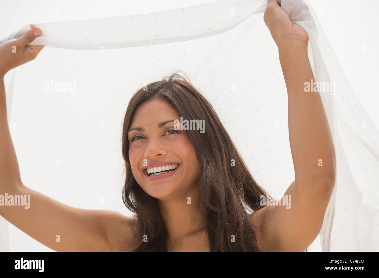 USA, New Jersey, Jersey City, Woman holding white cloth over head Stock ...