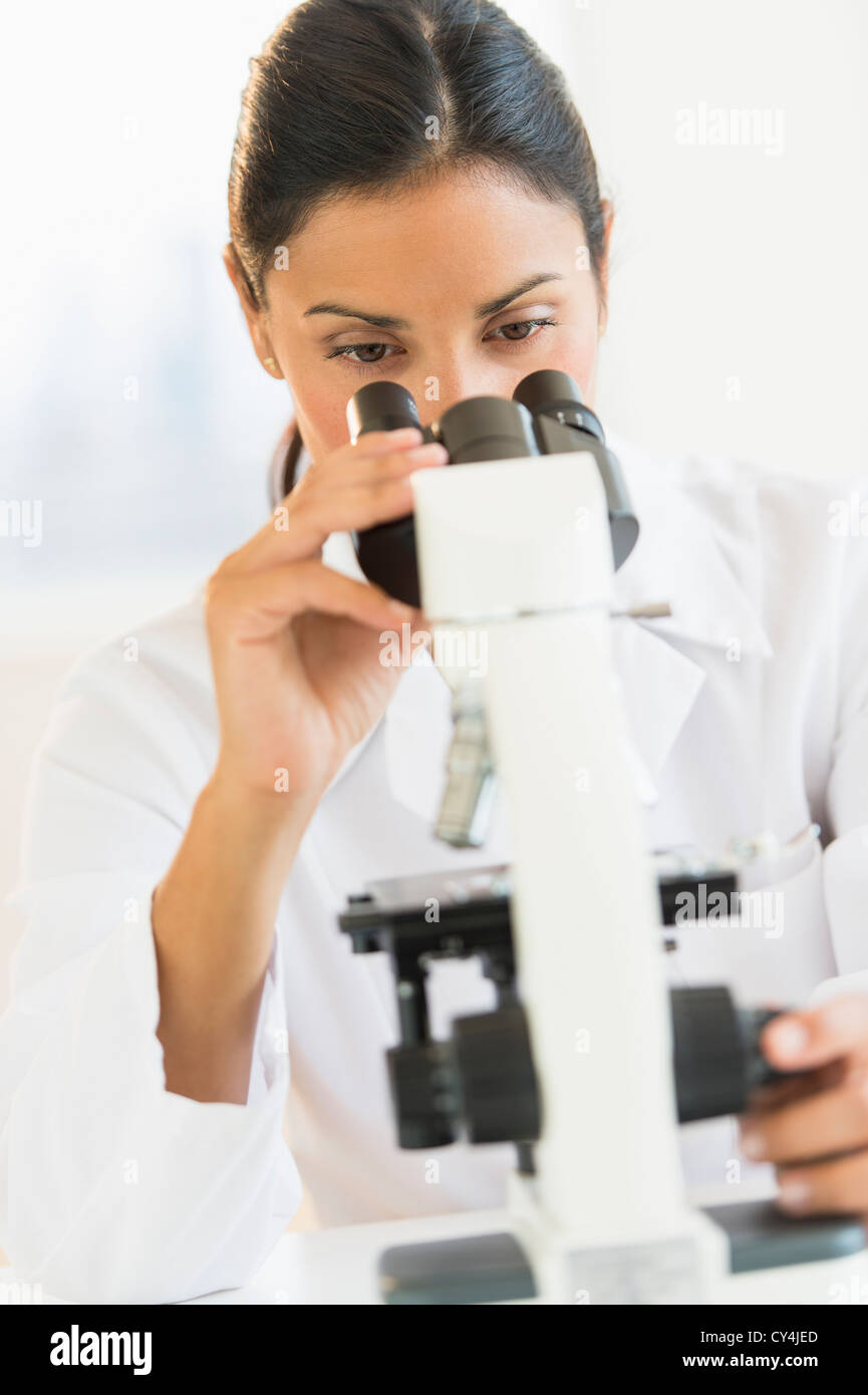 USA, New Jersey, Jersey City, Female scientist looking through ...