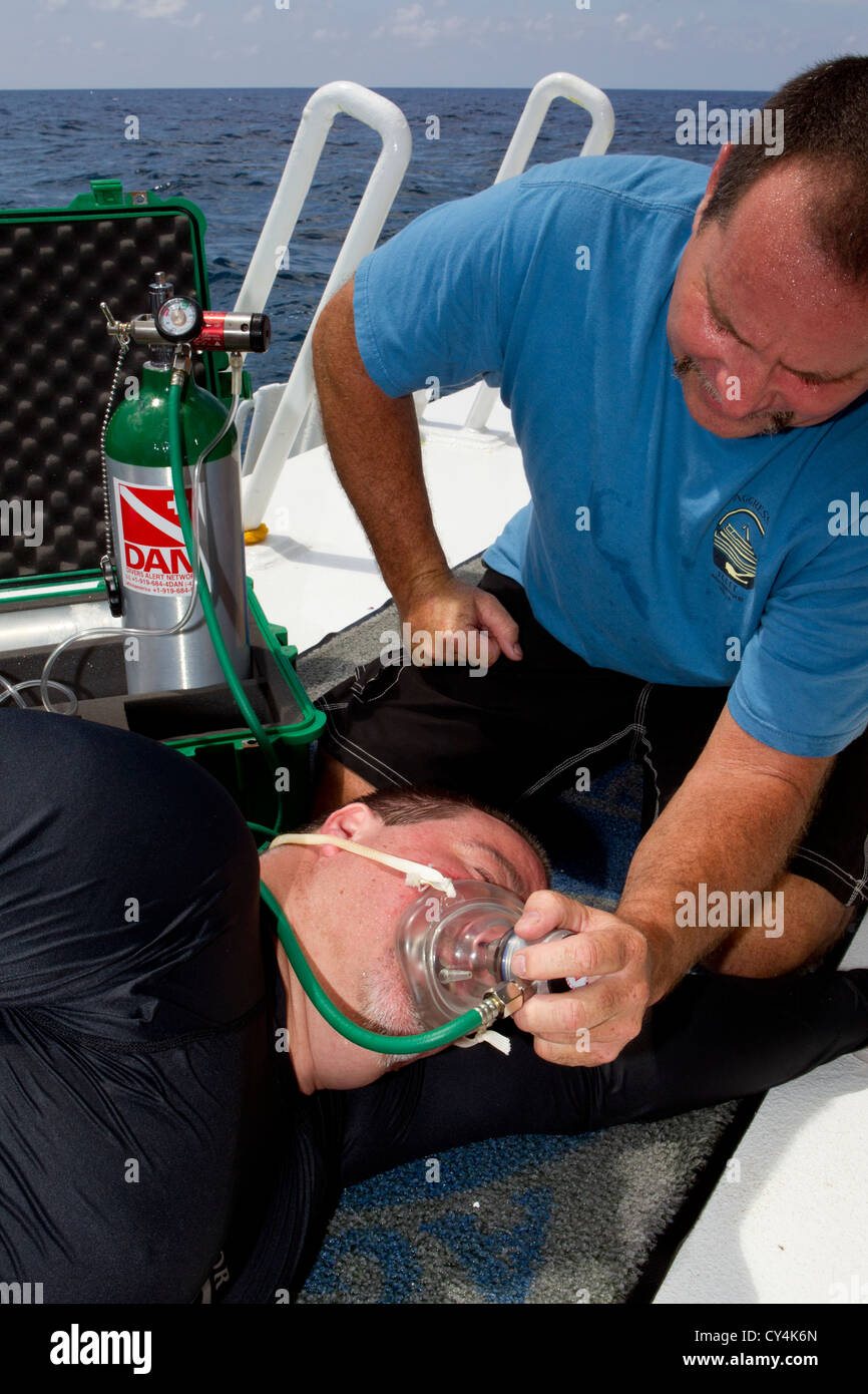 Crew of dive boat administers oxygen Stock Photo - Alamy